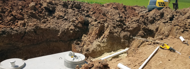 Concrete Septic holding tanks being buried • Martin Septic Service